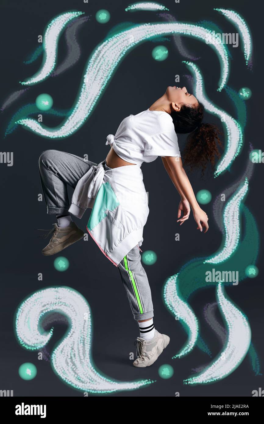 Beautiful female African-American hip-hop dancer on grey background ...