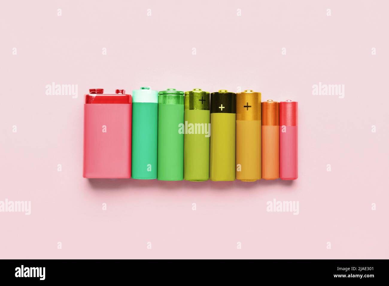 Set of colorful batteries on pink background. Concept of energy ...