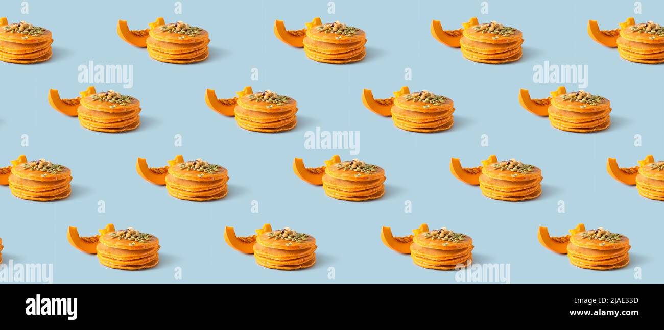 Many tasty pumpkin pancakes on light blue background. Pattern for ...