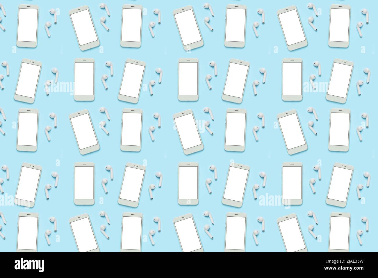 Many smartphones with blank screens and earphones on light blue ...