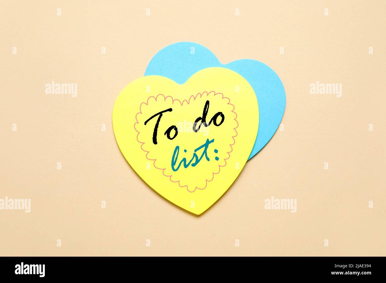 Heart-shaped note papers with blank to-do list on color background ...
