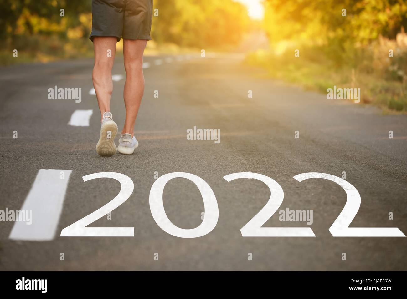 Sporty young man running down the road. Concept of 2022 goals Stock ...