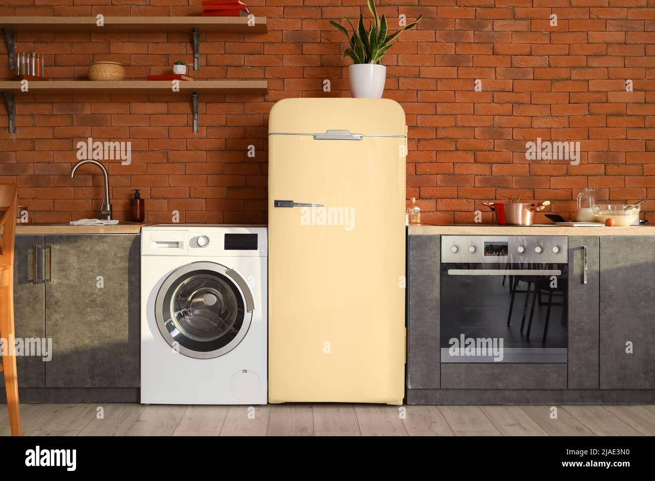 Interior of stylish kitchen with washing machine and retro fridge Stock ...