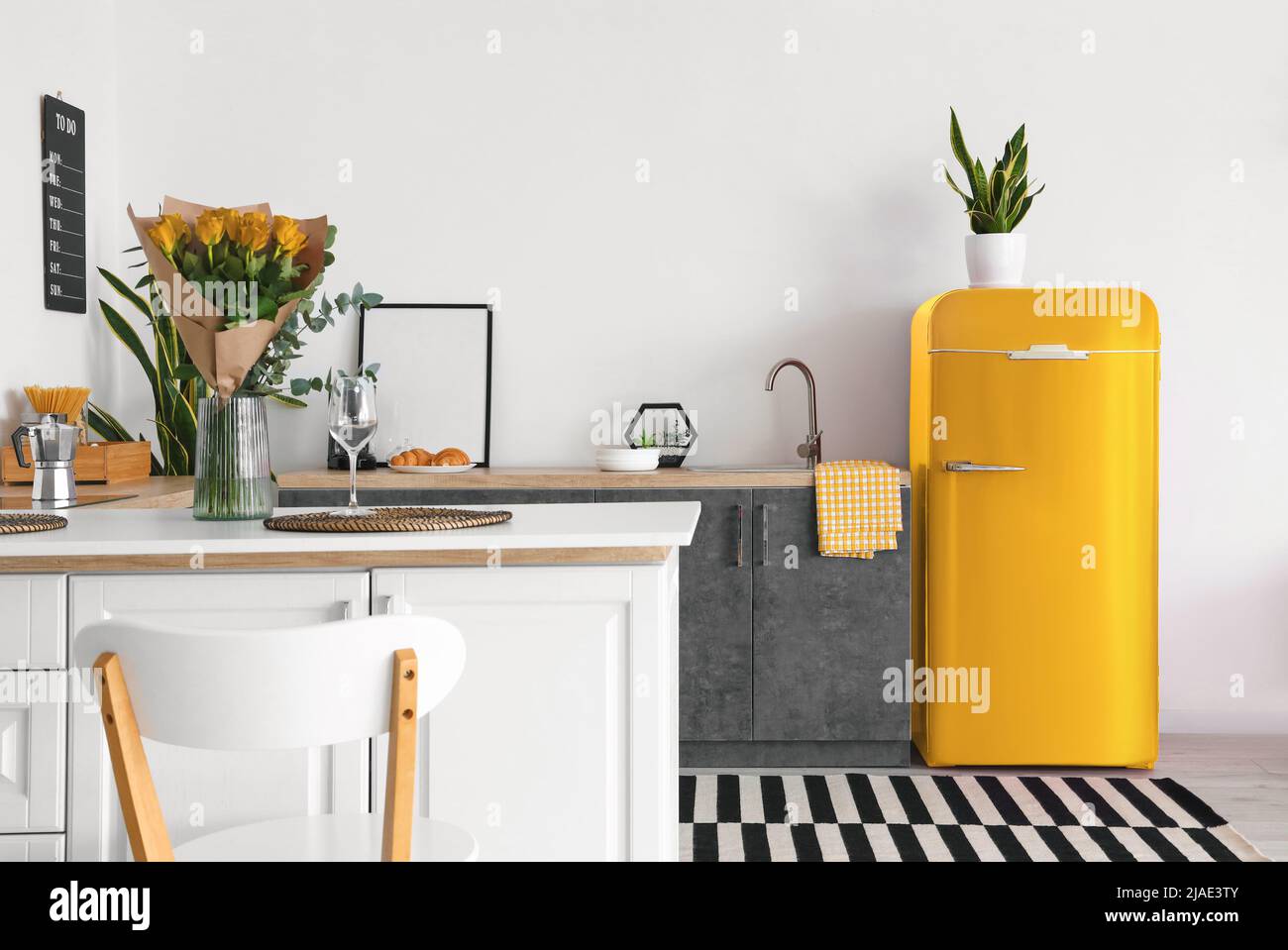 Interior of light kitchen with yellow fridge Stock Photo - Alamy