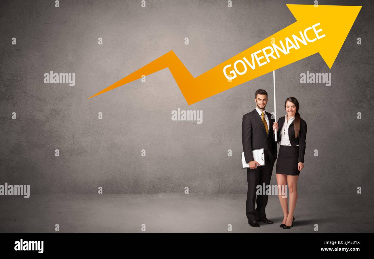 Young business person in casual holding road sign Stock Photo - Alamy