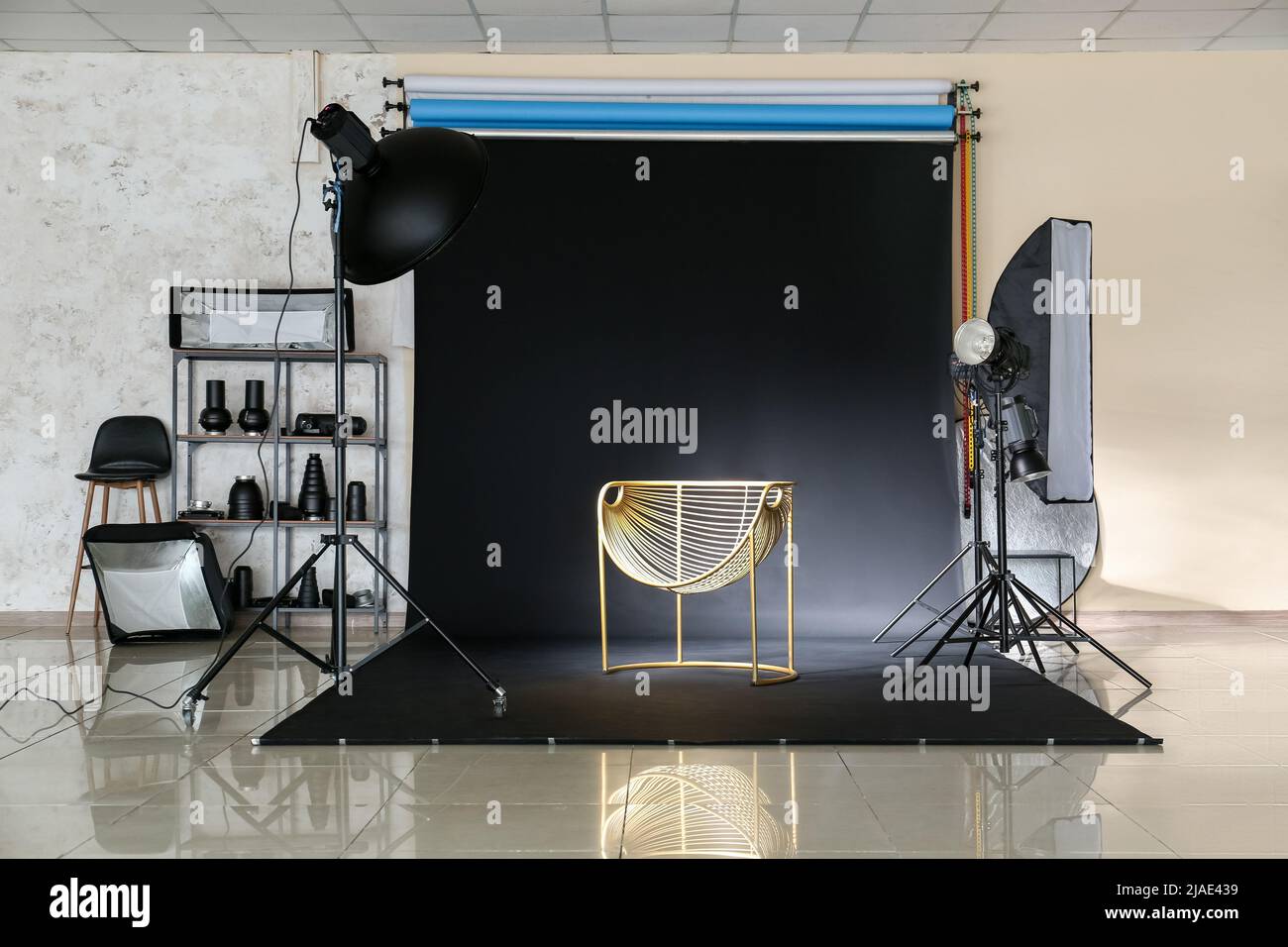 Lighting equipment, armchair and cyclorama in modern photo studio Stock ...