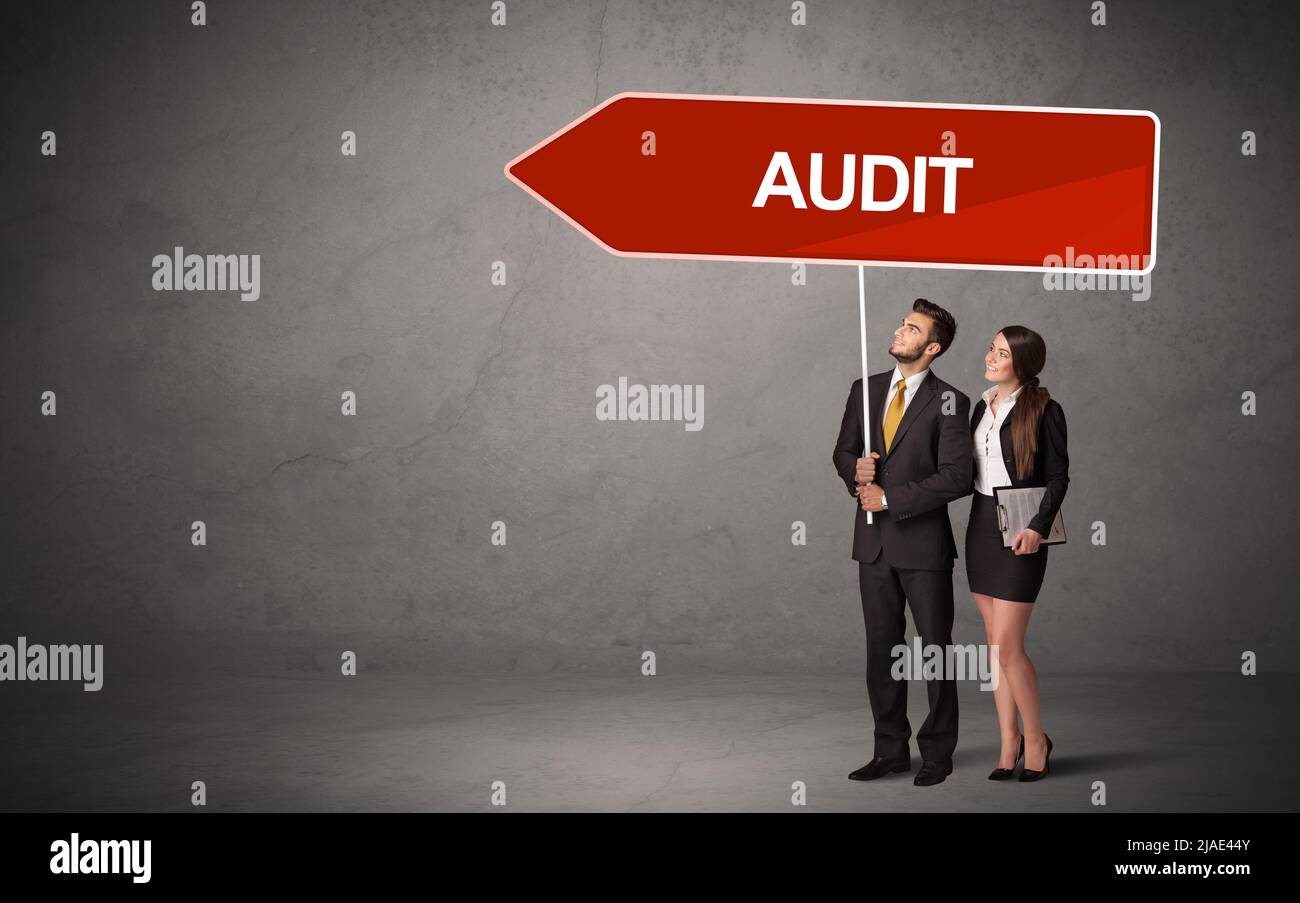 Young business person in casual holding road sign Stock Photo - Alamy