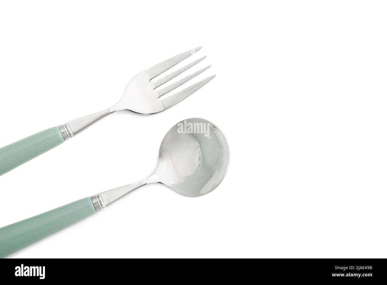 Stainless steel spoon and fork with grey handle on white background ...