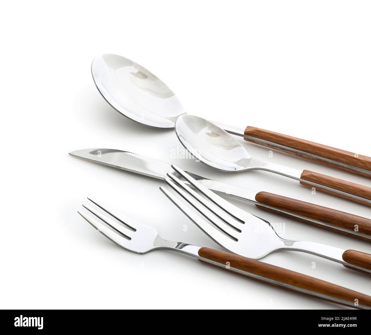 Set of stainless steel cutlery with wooden handle on white background ...