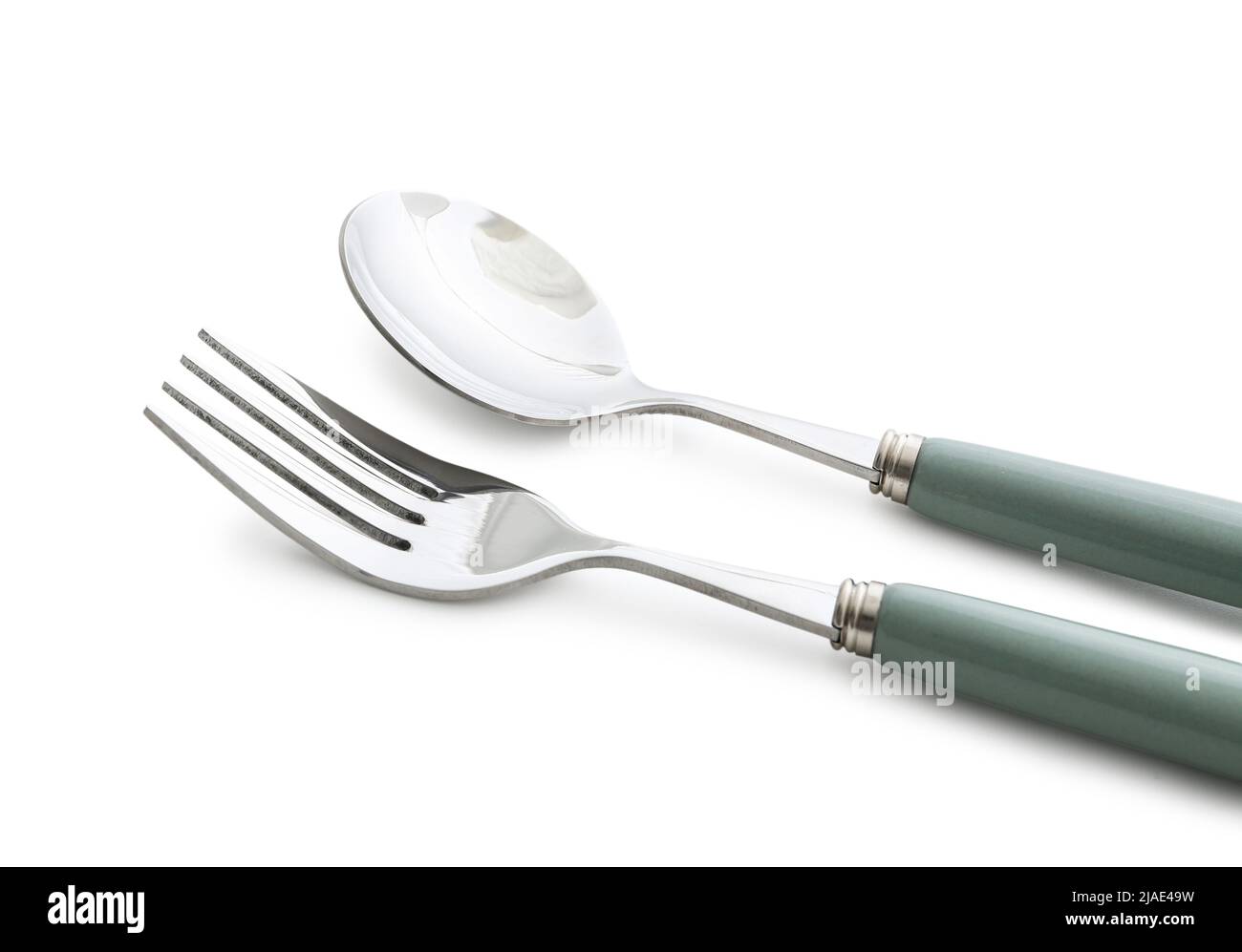 Stainless steel spoon and fork with green handle on white background ...