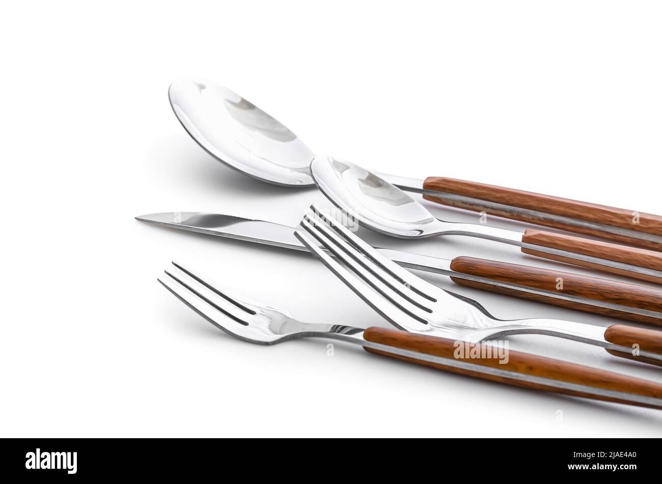 Set of stainless steel cutlery with wooden handle on white background ...