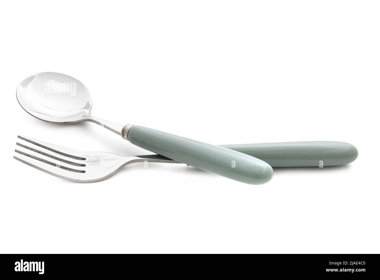 Stainless steel spoon and fork with green handle on white background ...