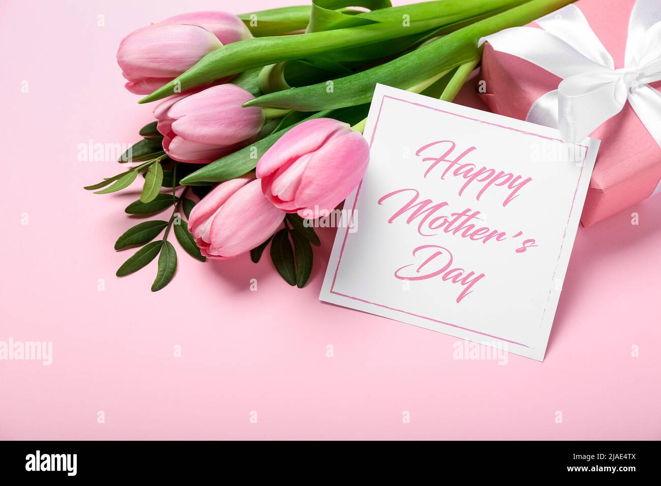 Card with text HAPPY MOTHER'S DAY, tulips and gift box on pink ...