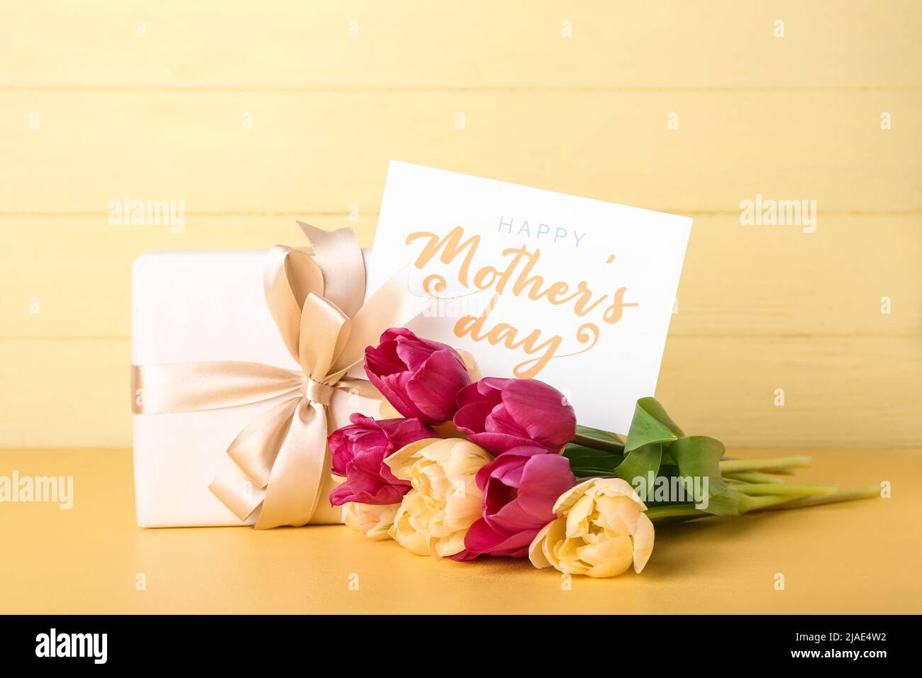 Card with text HAPPY MOTHER'S DAY, gift box and bouquet of tulips on ...