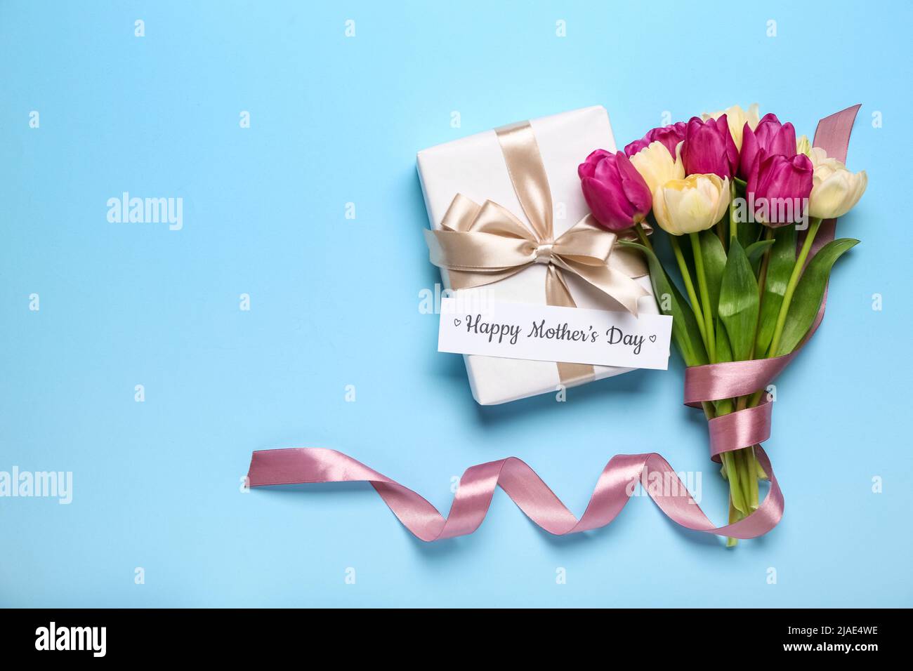 Paper with text HAPPY MOTHER'S DAY, gift box and bouquet of tulips on ...
