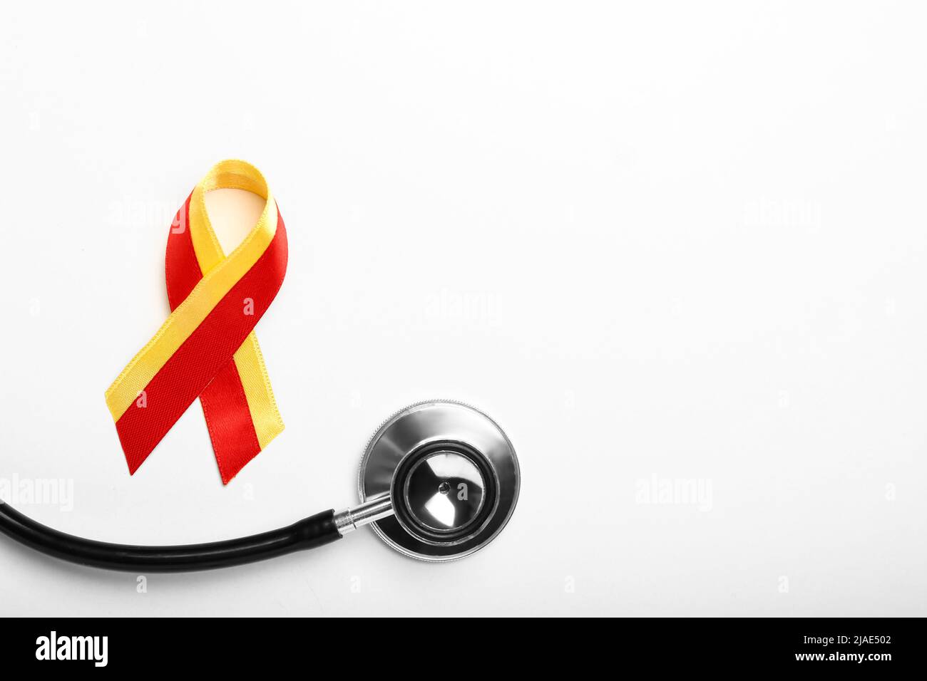 Awareness ribbon with stethoscope on white background. Hepatitis ...