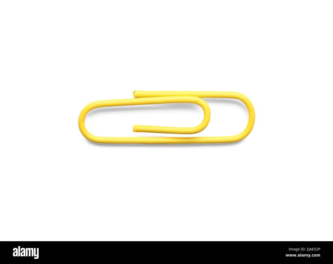 Yellow paper clip on white background Stock Photo - Alamy