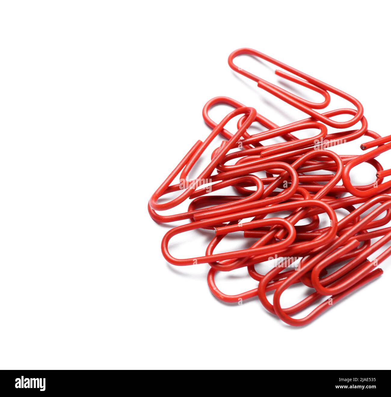 Red paper clips on white background Stock Photo - Alamy