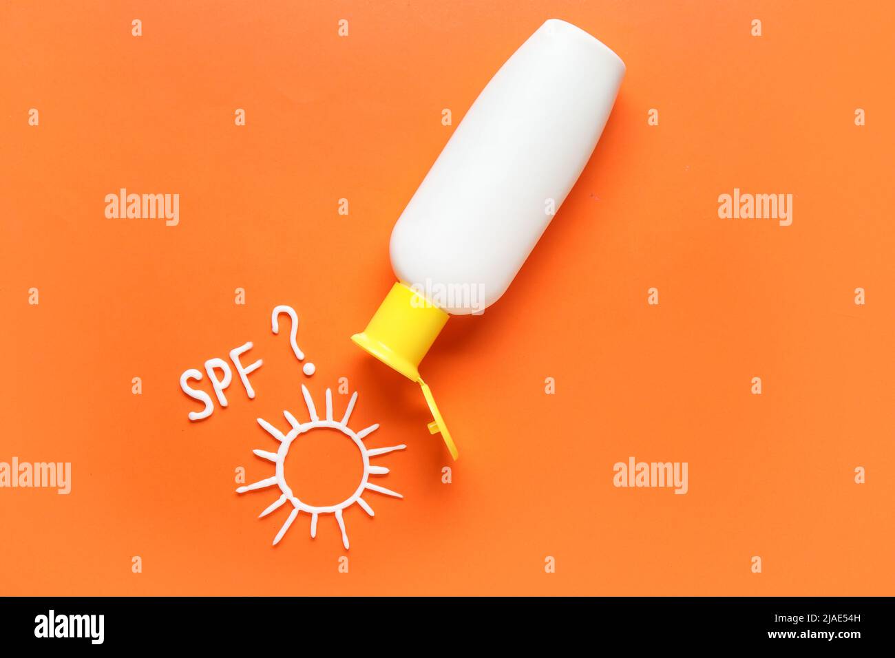 Drawing of sun and question SPF? made with sunscreen cream on color ...