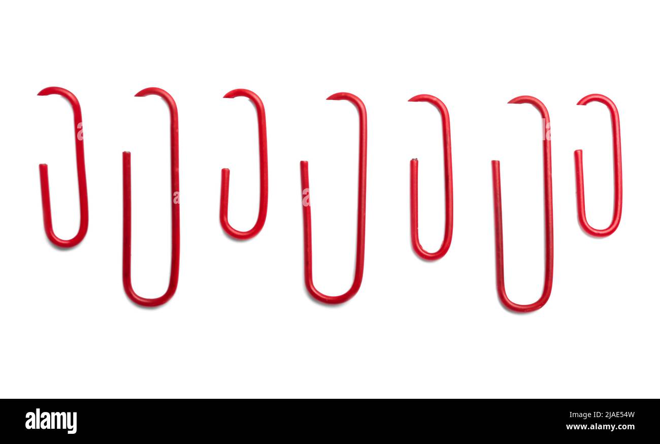 Red paper clips on white background Stock Photo - Alamy