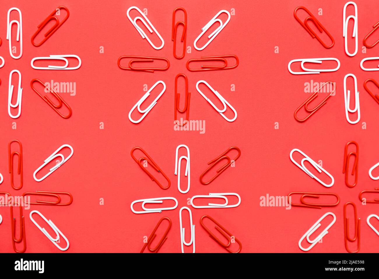 White and red paper clips on color background Stock Photo - Alamy