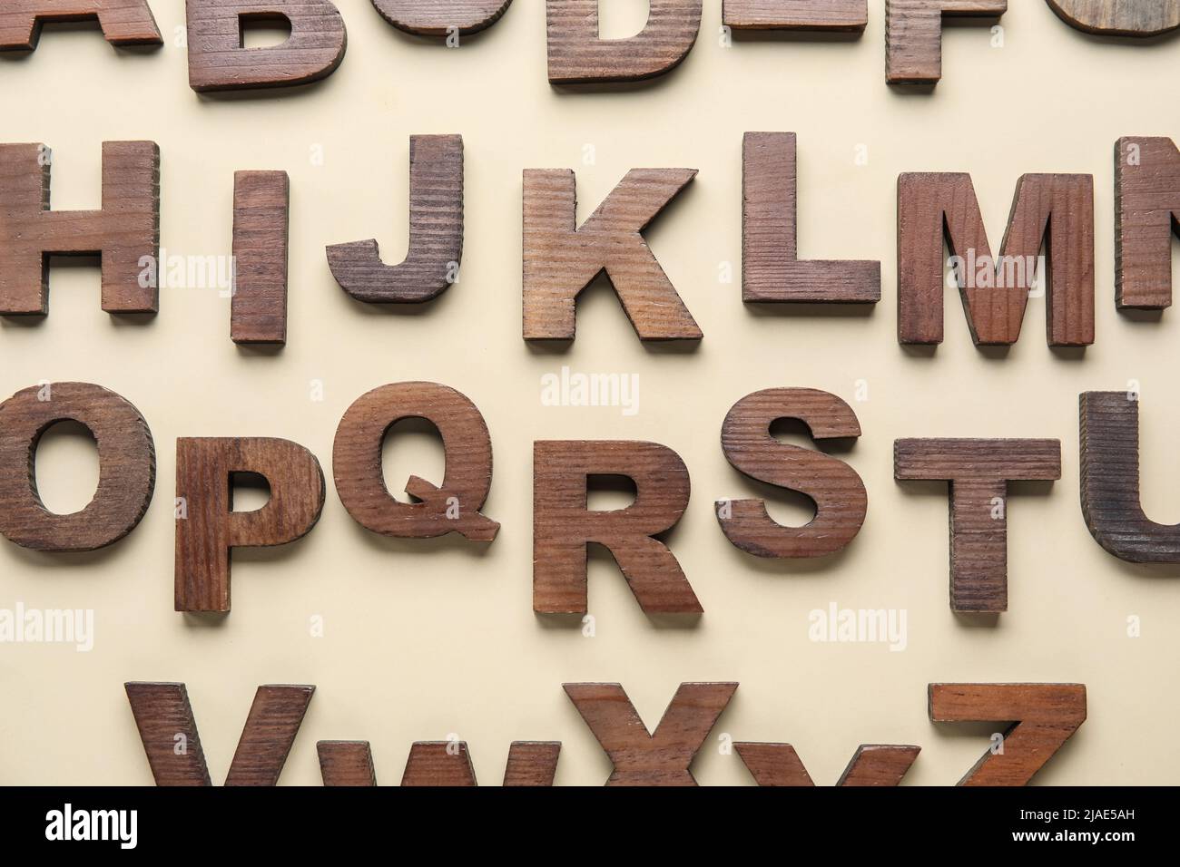 Wooden letters on beige background. Alphabet concept Stock Photo - Alamy