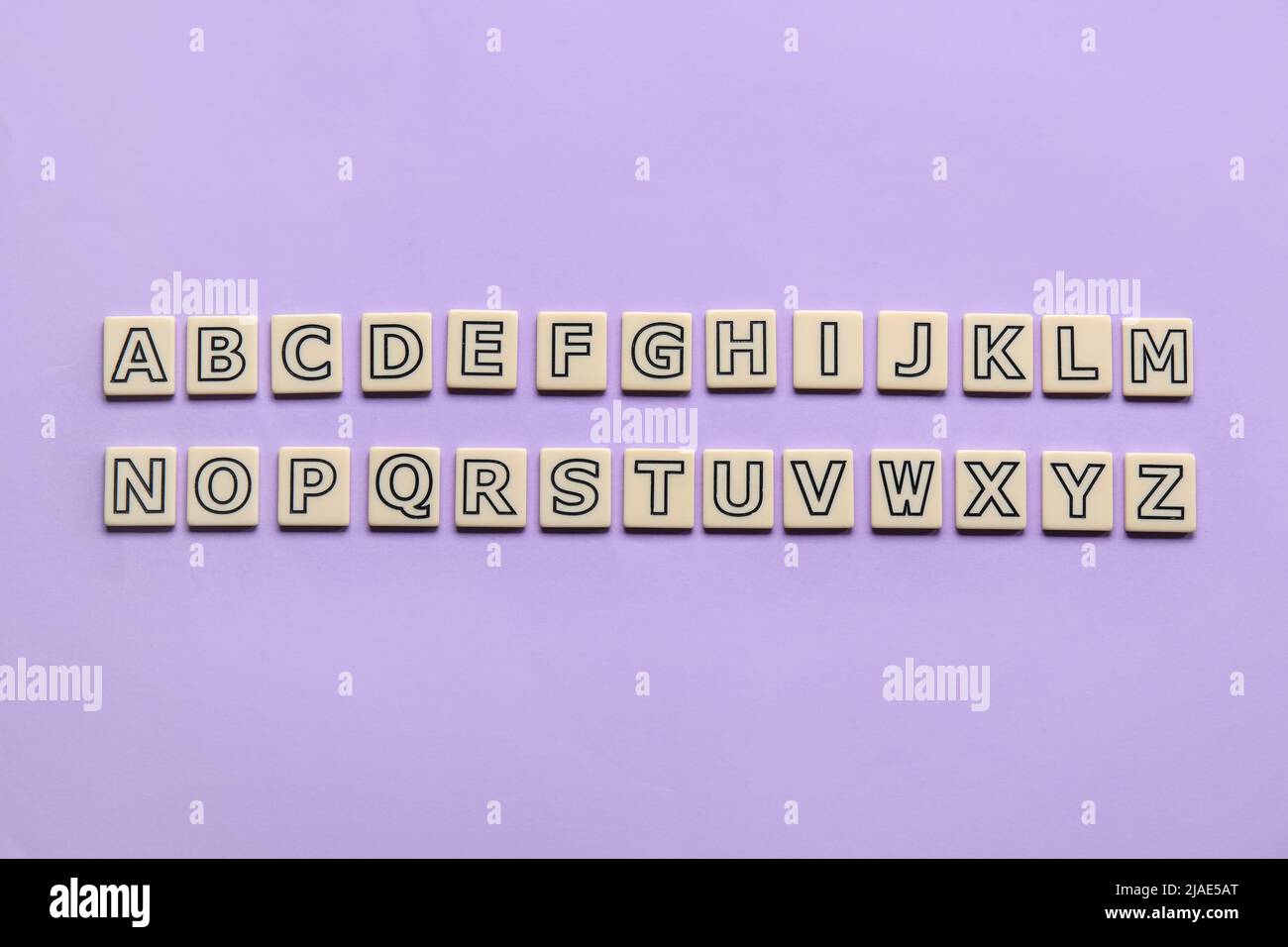 Different letters on lilac background. Alphabet concept Stock Photo - Alamy