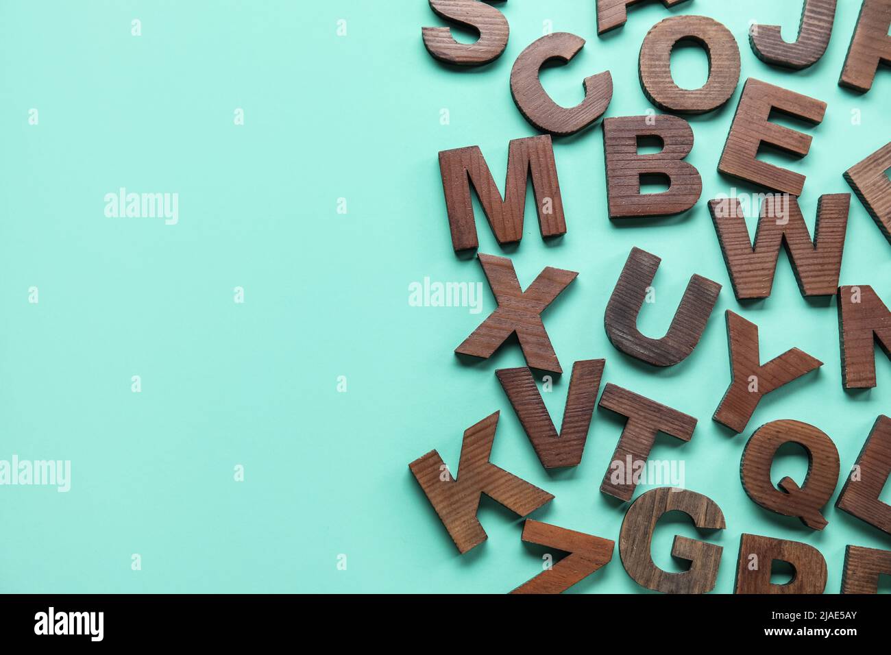 Wooden letters on blue background. Alphabet concept Stock Photo - Alamy