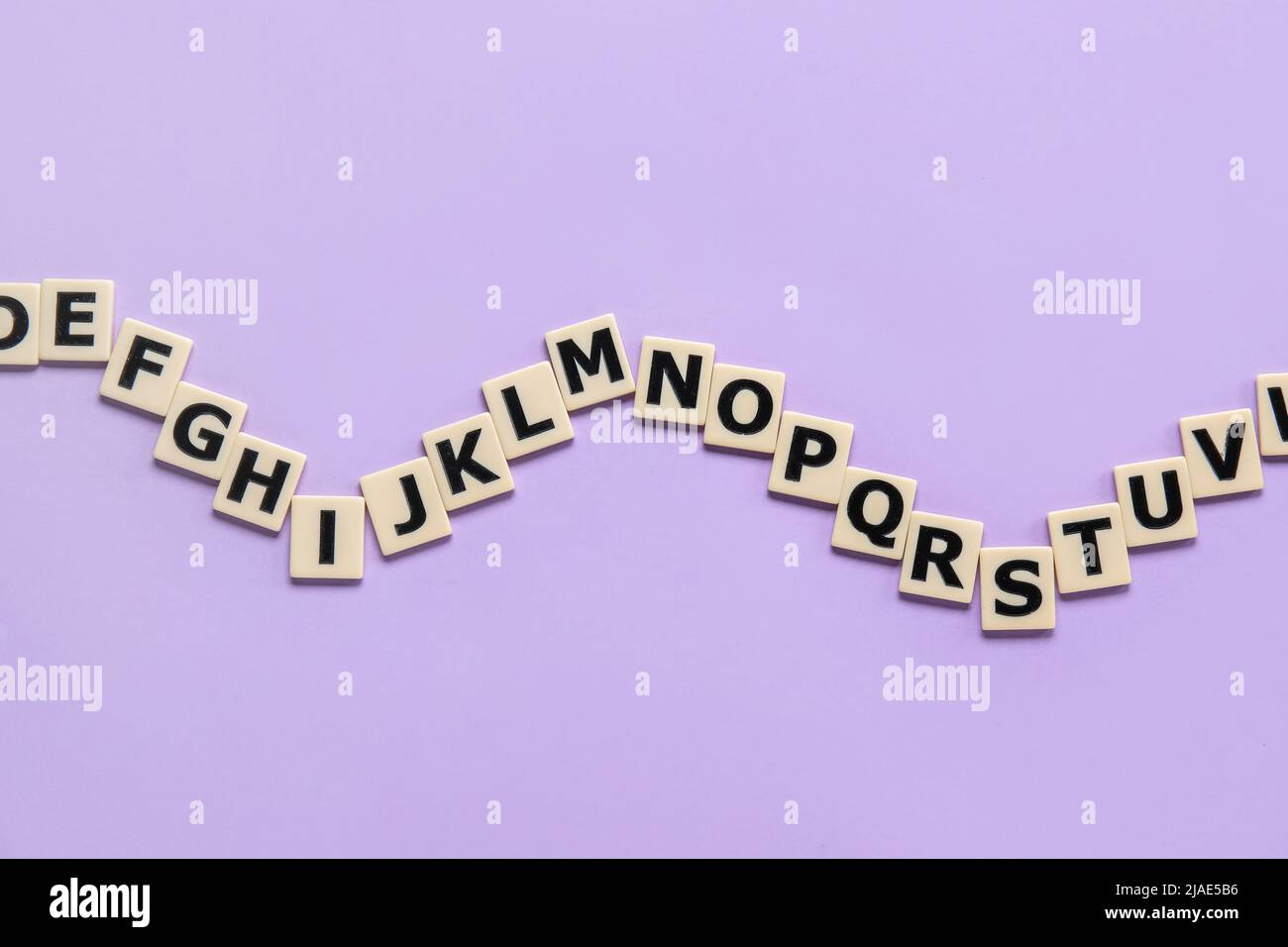 Different letters on lilac background. Alphabet concept Stock Photo - Alamy