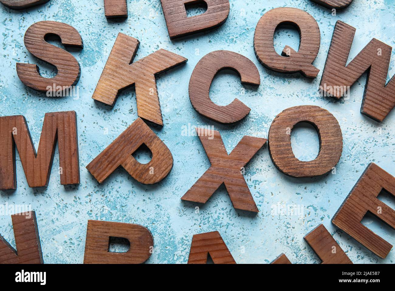 Wooden letters on grunge background. Alphabet concept Stock Photo - Alamy