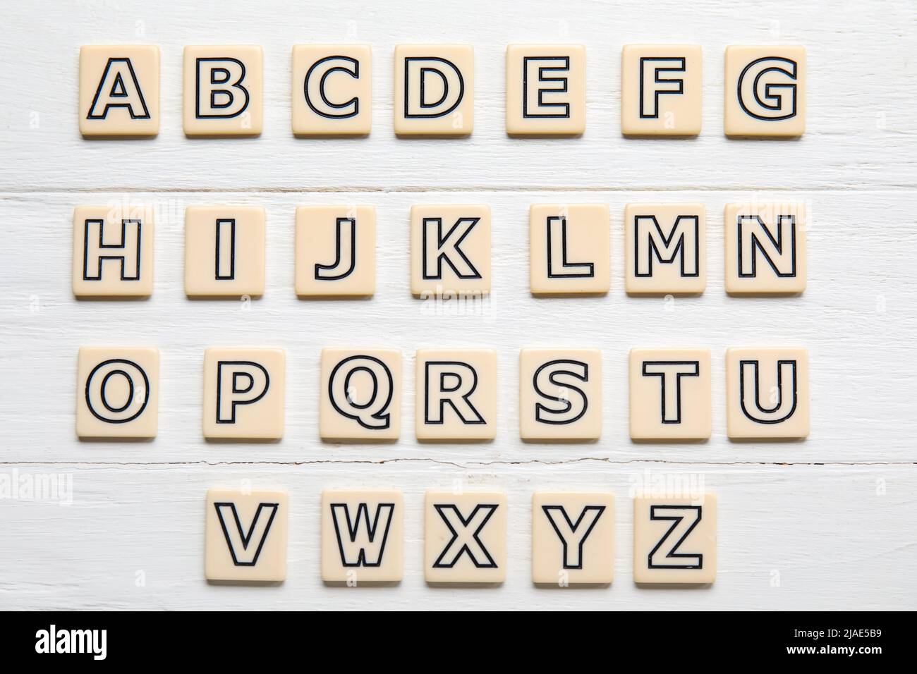 Different letters on white wooden background. Alphabet concept Stock ...