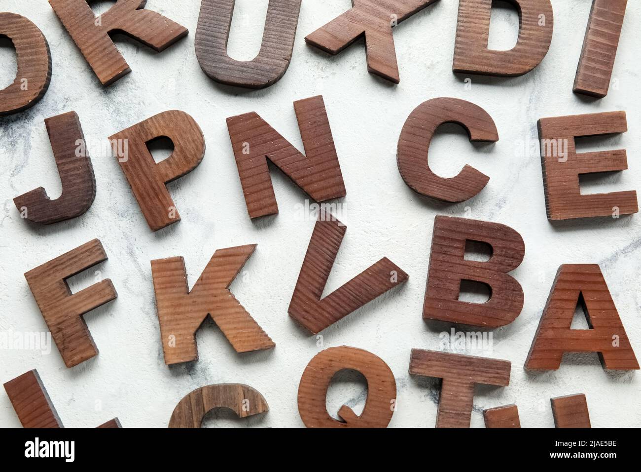Wooden letters on light background. Alphabet concept Stock Photo - Alamy