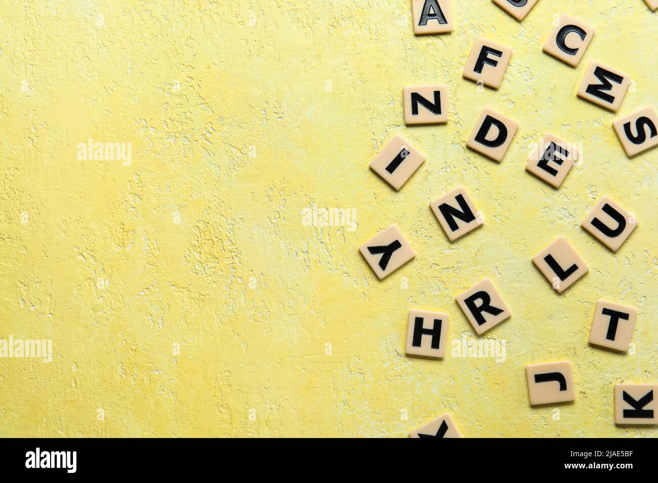 Different letters on yellow background. Alphabet concept Stock Photo ...