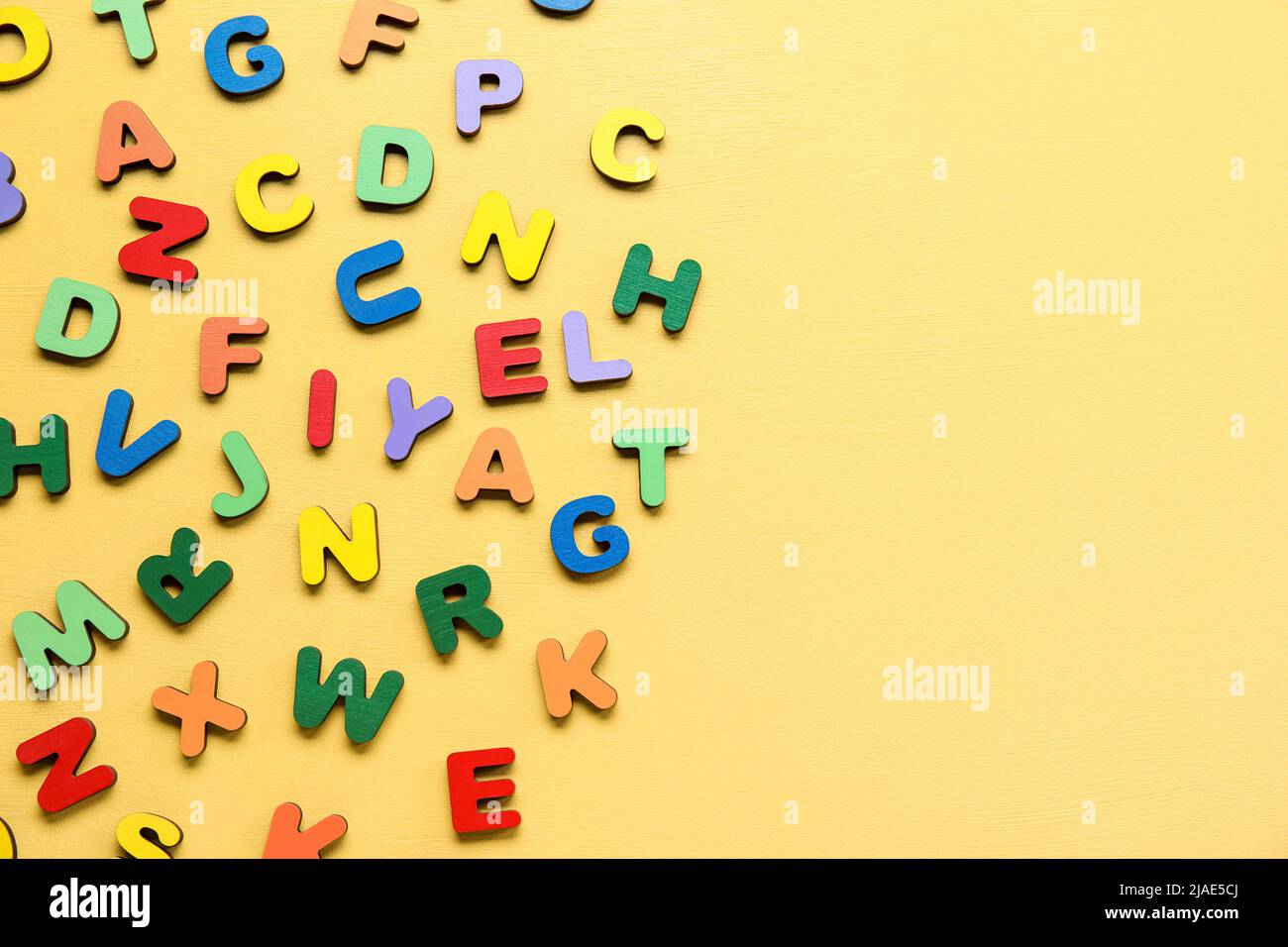 Colorful letters on yellow background. Alphabet concept Stock Photo - Alamy