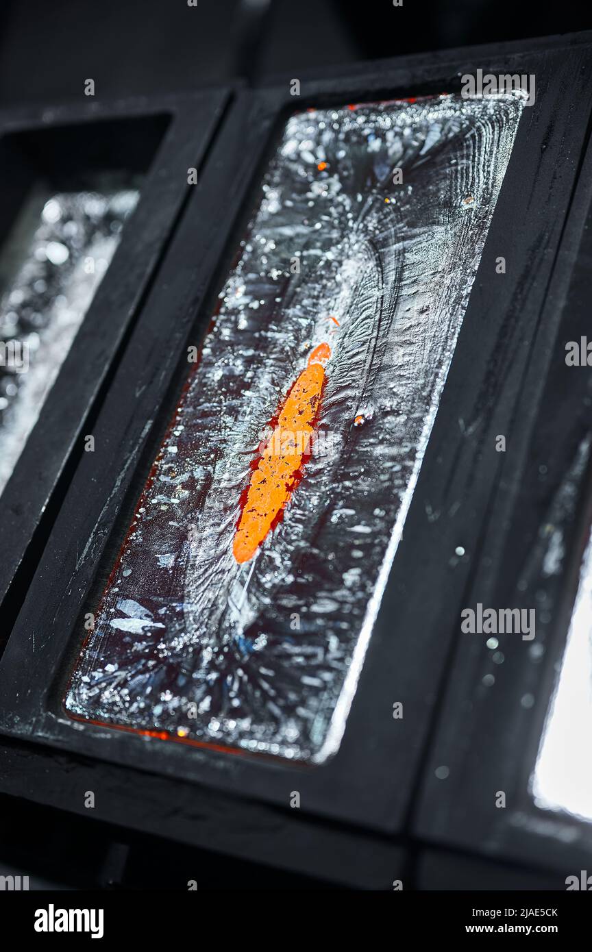 Silver ingot with hot center cools down in casting form Stock Photo - Alamy