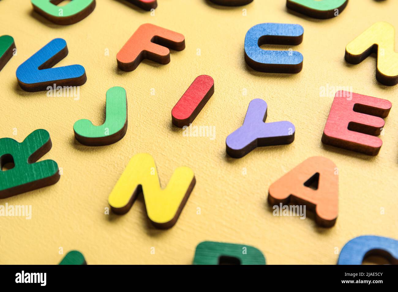 Colorful letters on yellow background. Alphabet concept Stock Photo - Alamy