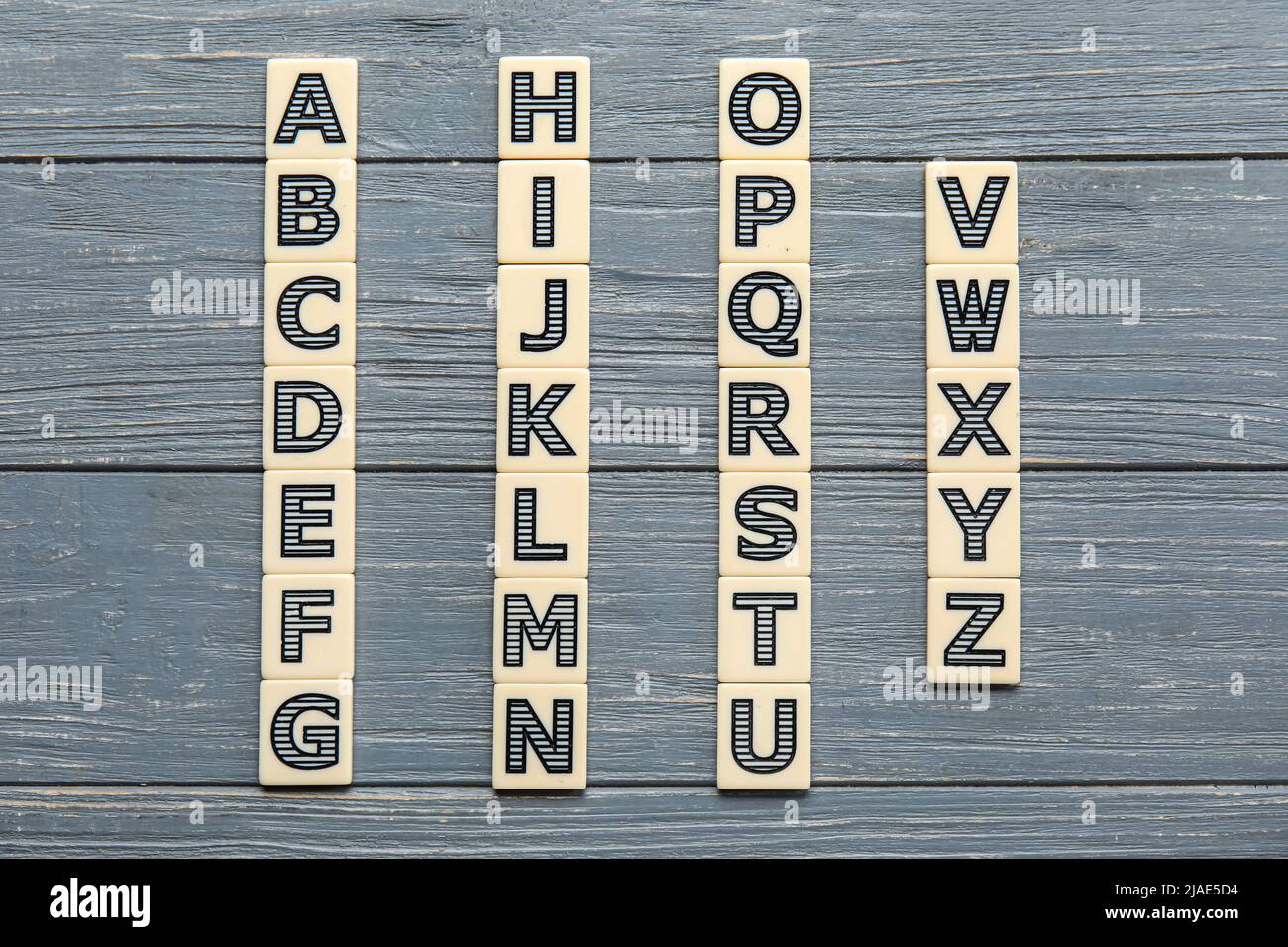 Different letters on grey wooden background. Alphabet concept Stock ...