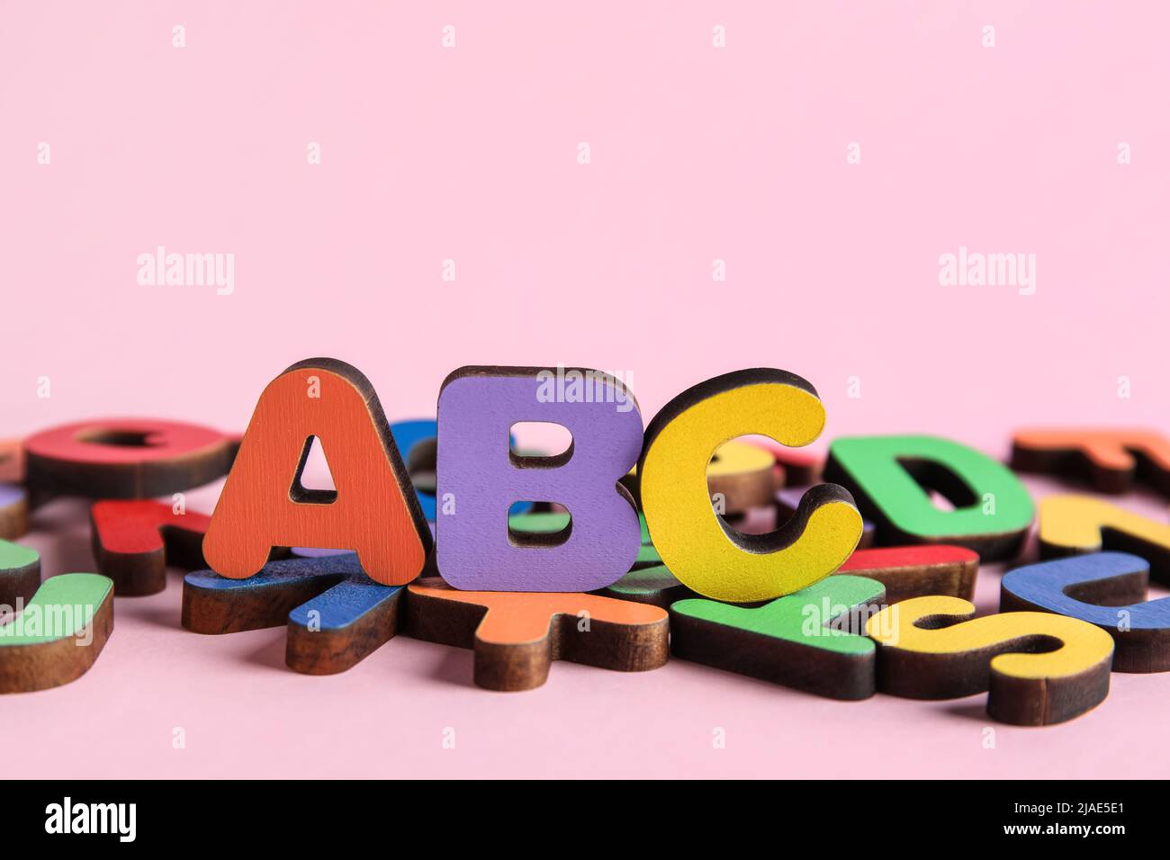 Colorful letters on pink background. Alphabet concept Stock Photo - Alamy