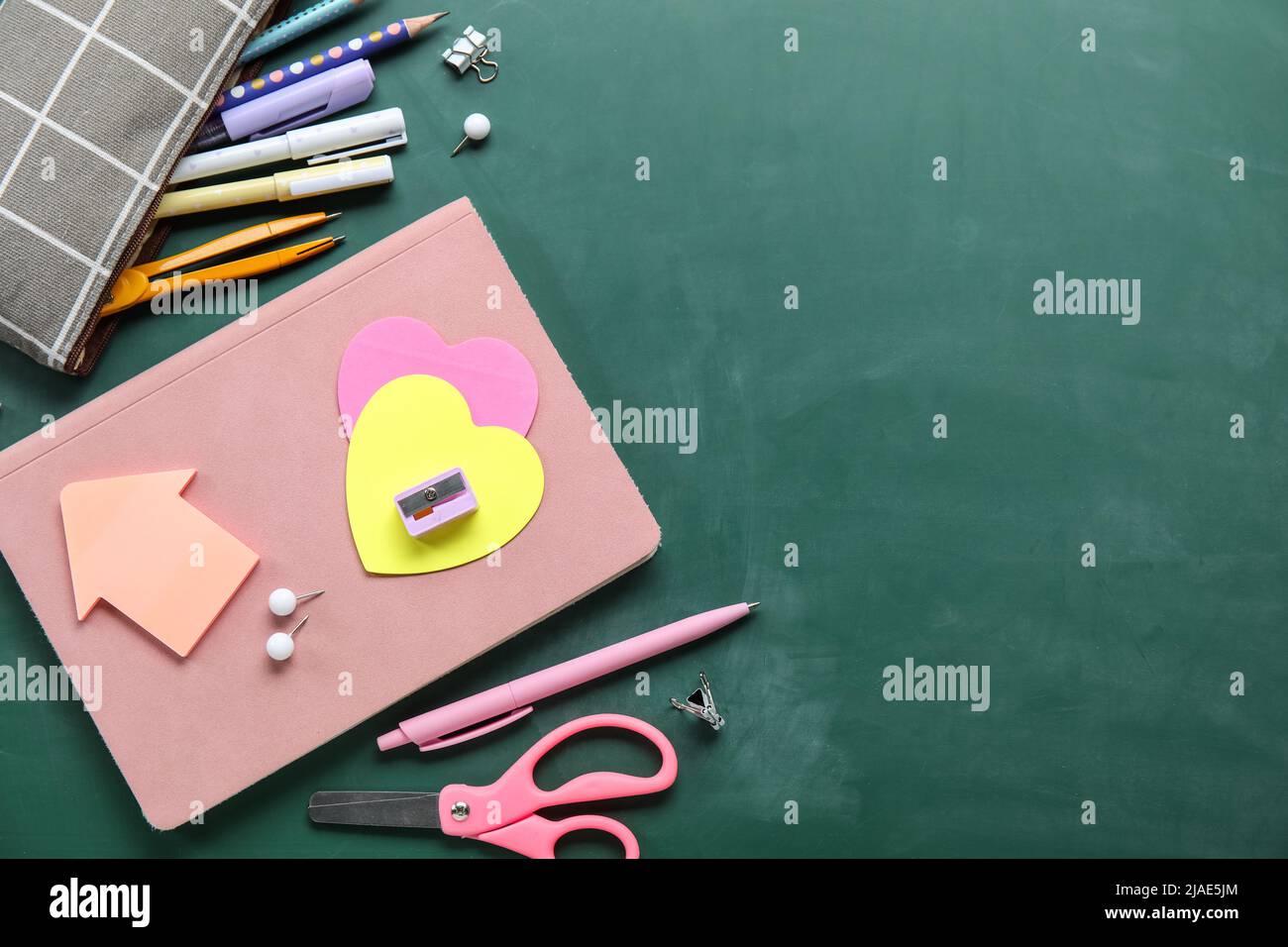 Stationery supplies on school chalkboard, top view Stock Photo - Alamy