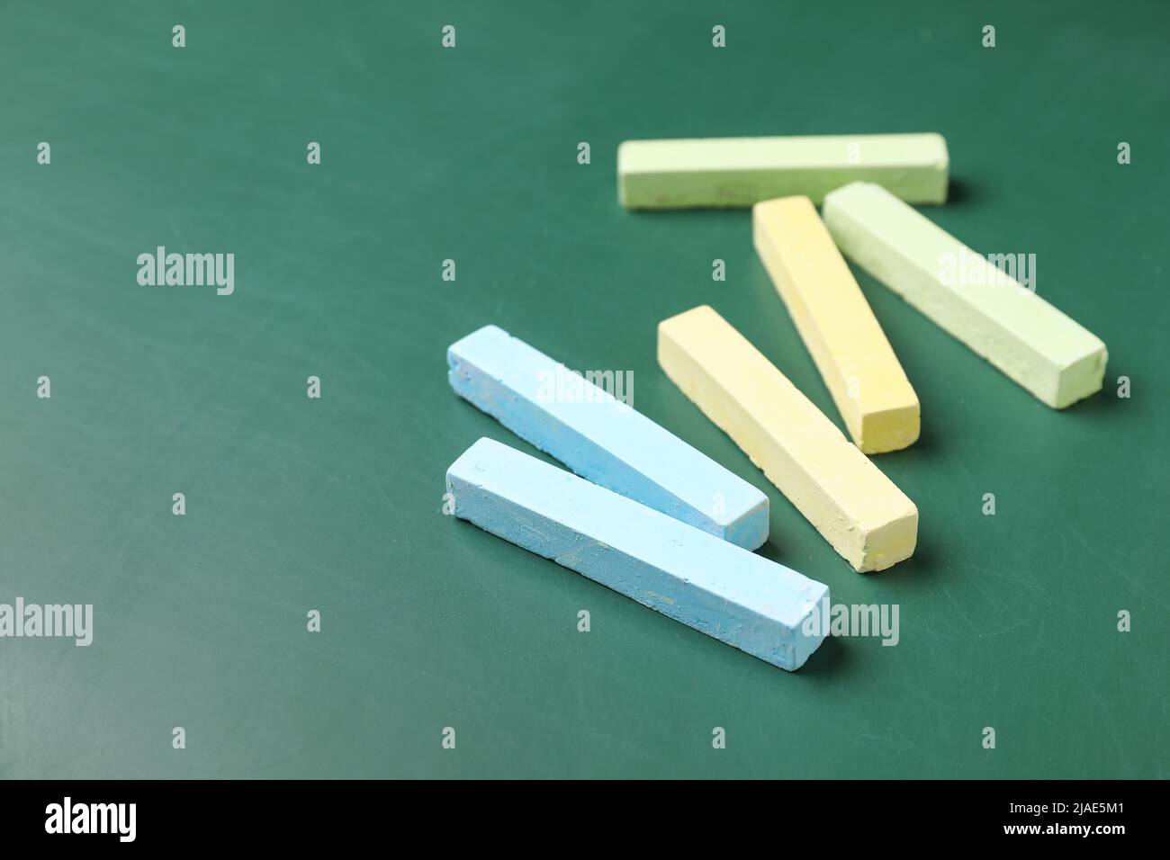 Colorful chalks on green blackboard Stock Photo - Alamy