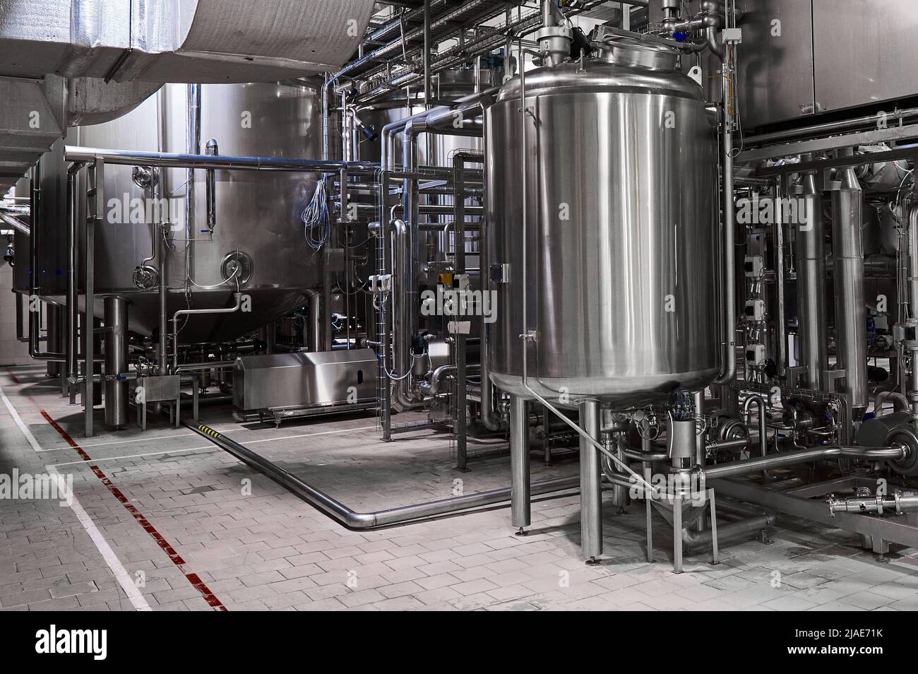 Metal ground near large cisterns for fermented milk products Stock ...