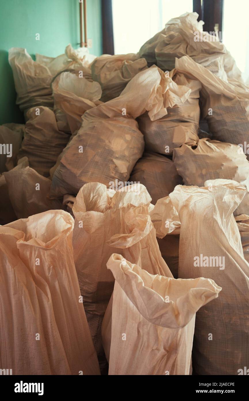 Garbage sack bags with pieces of destroyed wall in apartment under ...