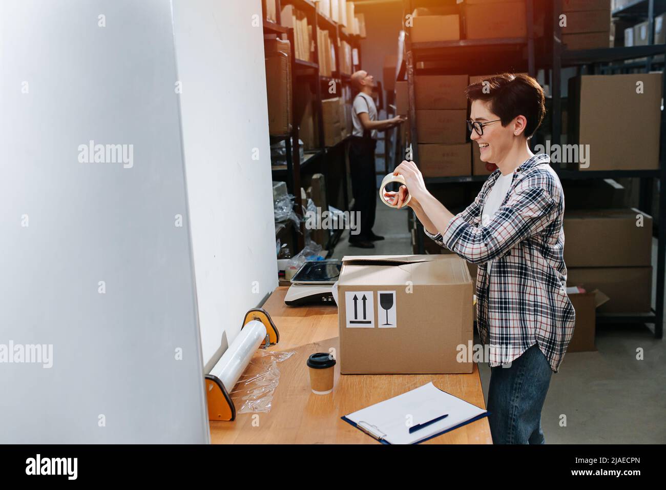 Female worker packing box in warehouse hi-res stock photography and ...