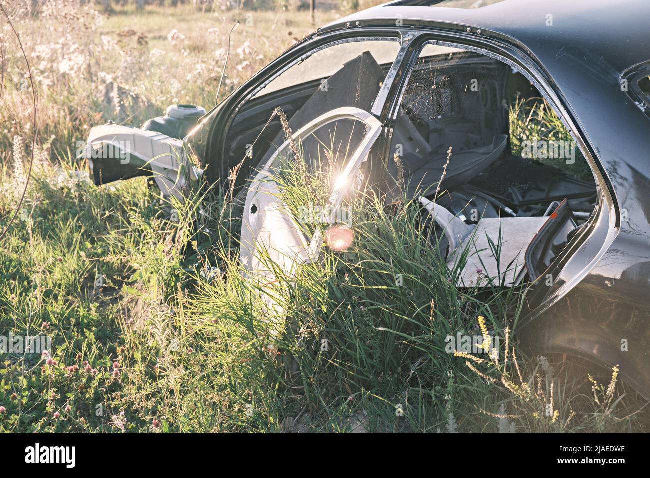 Car dump, scrap metal. Close-up of an old abandoned car in a junkyard ...