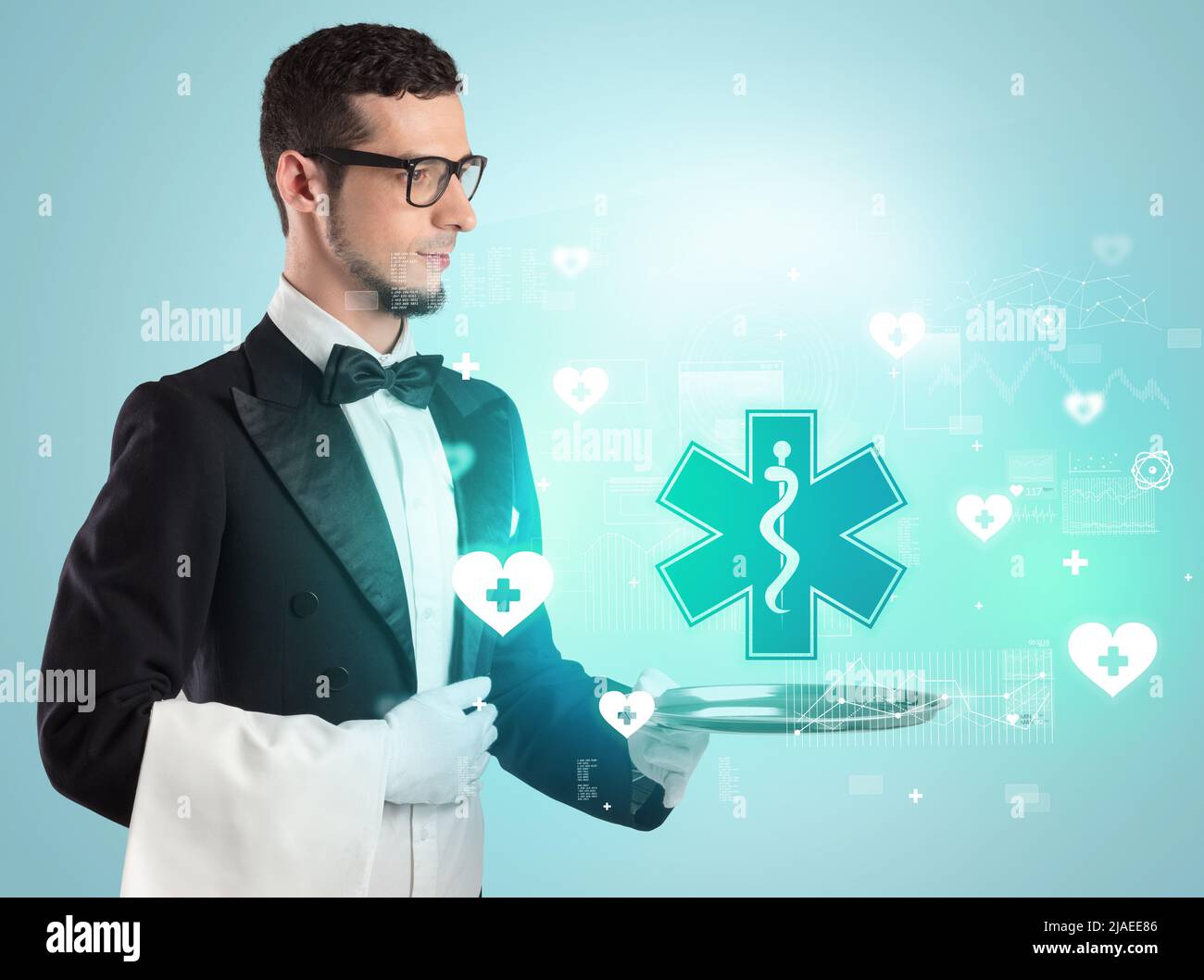 Handsome young waiter in tuxedo holding healthcare icons on tray Stock ...