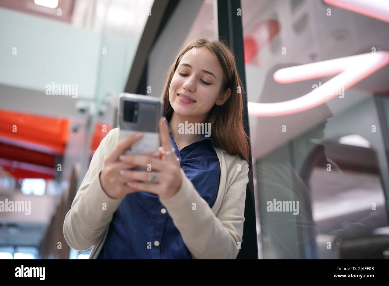 Young attractive female using a mobile phone for social media and using ...