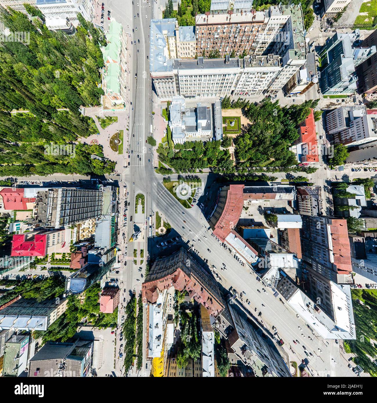 Aerial city view with crossroads, roads, houses, buildings, parks and ...