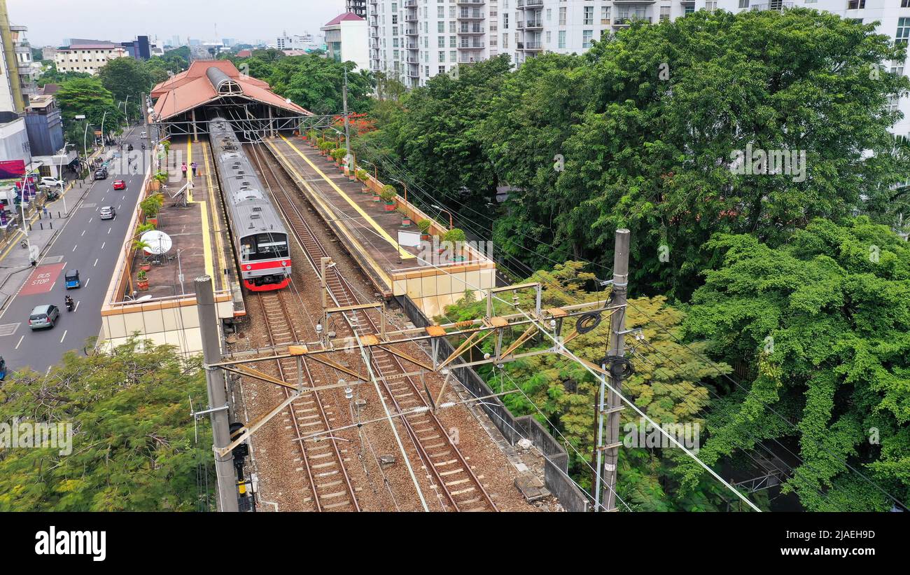 Aerial drone view of Commuter Line with electric train at the station ...