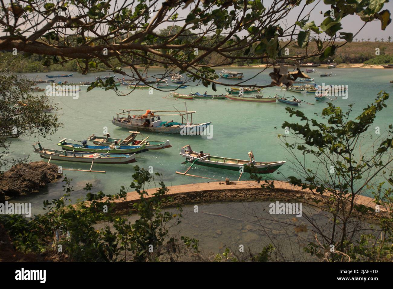 Fishing boats and a concrete pathway on Pero beach in Pero Batang ...