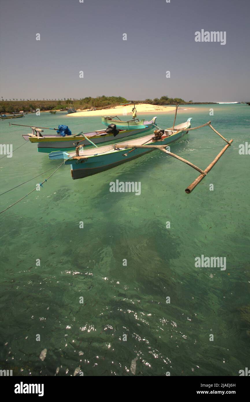 Fishing boats on sea water on a lagoon-like seascape in the fishing ...